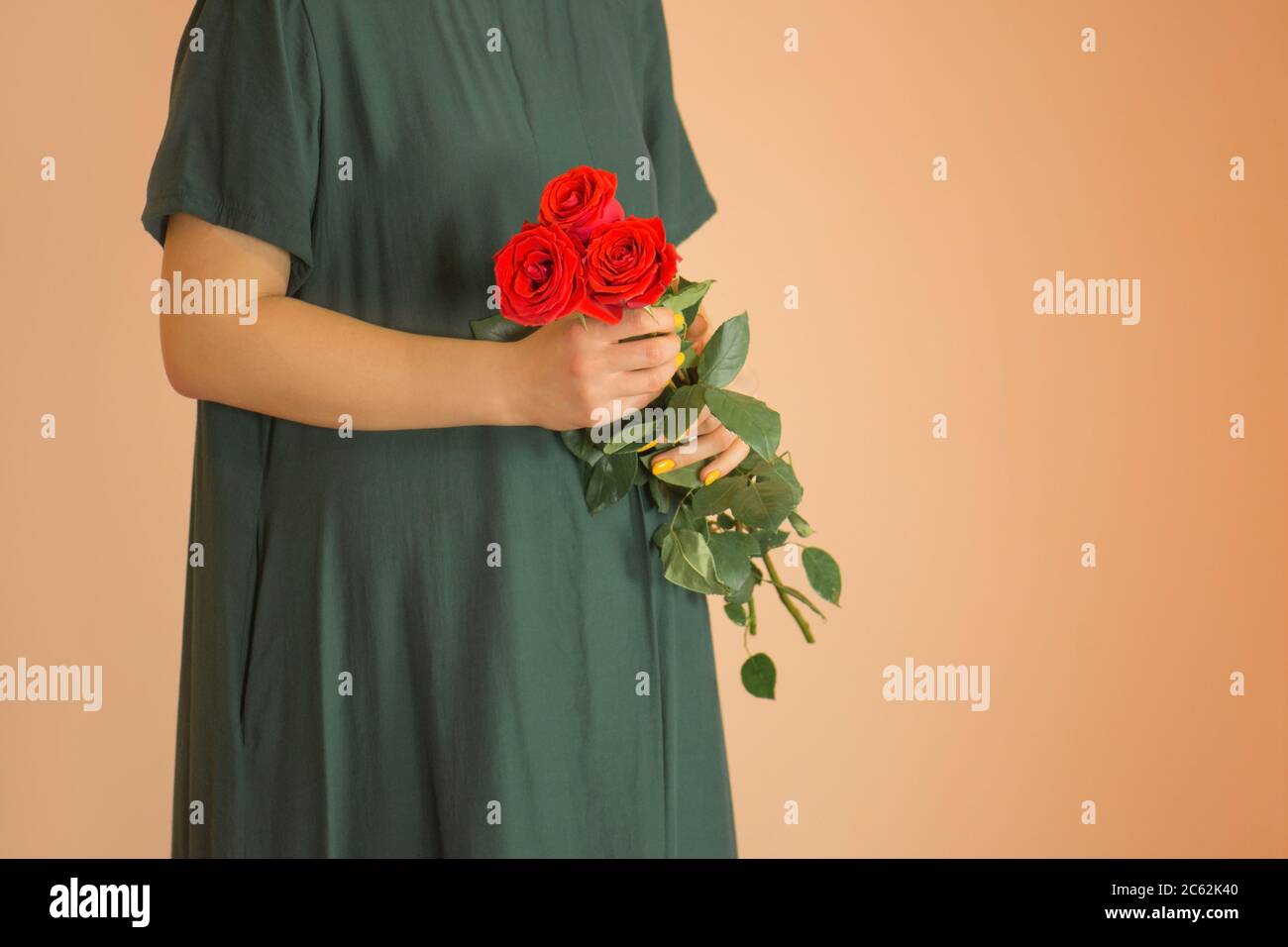 Young beautiful girl in a strict modest, discreet, long green dress ...