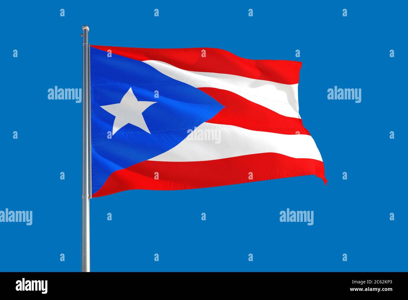 Puerto Rico national flag waving in the wind on a deep blue sky. High ...