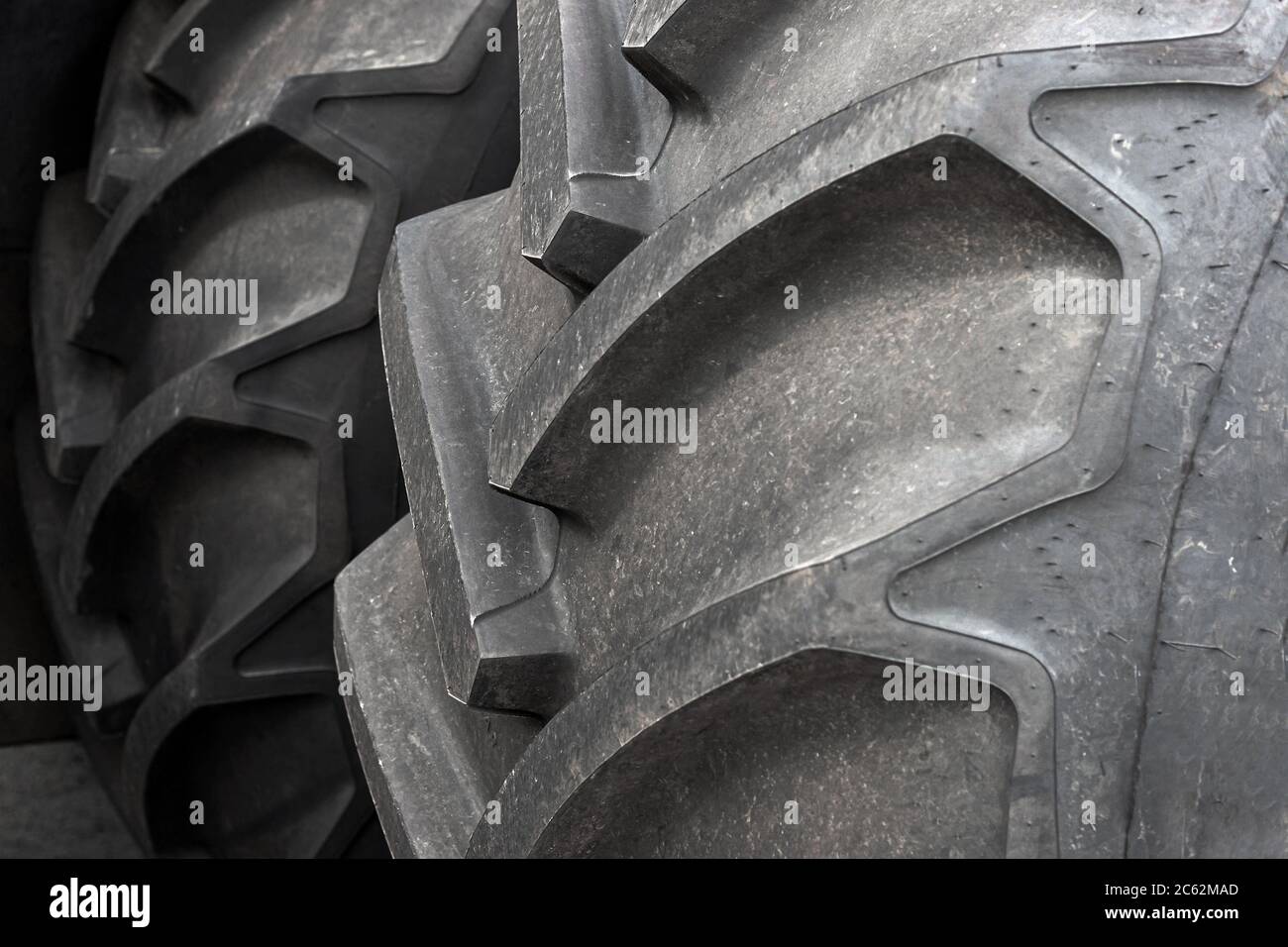 Two large wheels from a tractor or agricultural machinery close-up. The ...