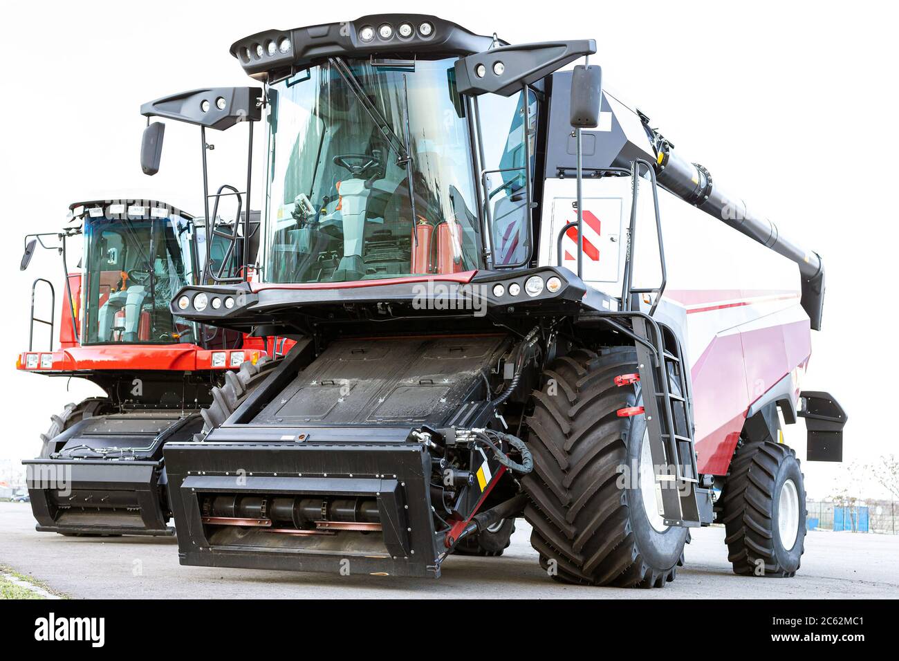 Two combines for harvesting grain. Large agricultural tractor on a ...