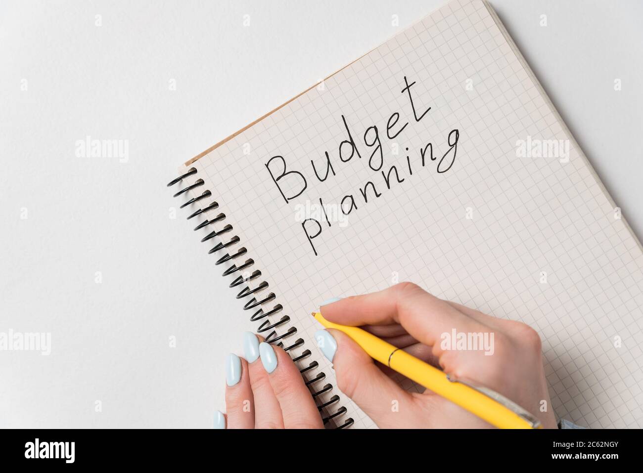 Budget planning concept. Female hand holding pen and writing in ...