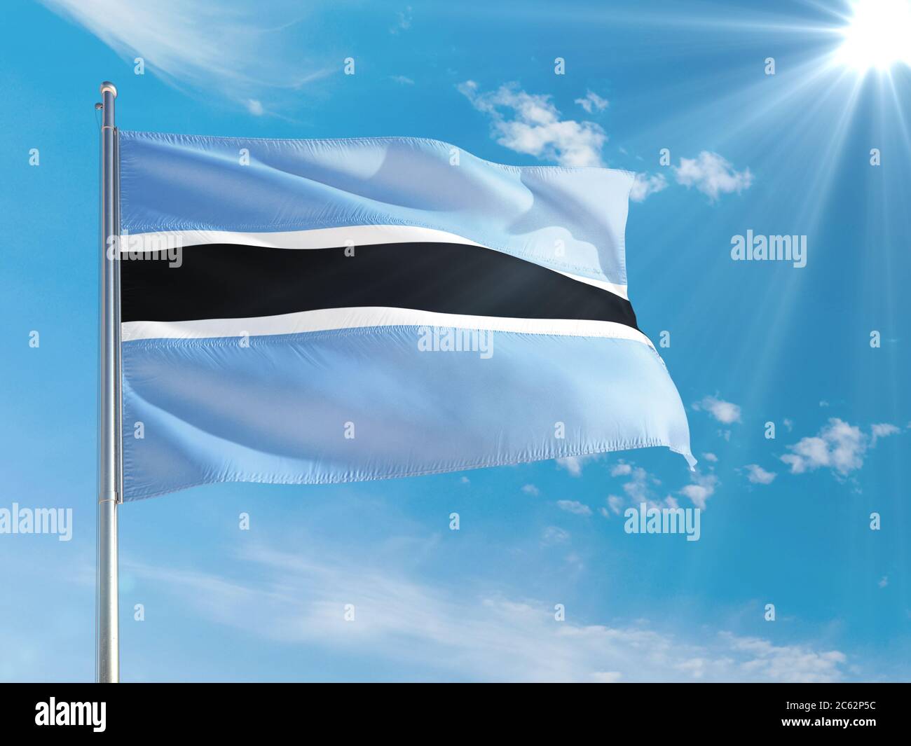 Botswana national flag waving in the wind against deep blue sky. High quality fabric ...