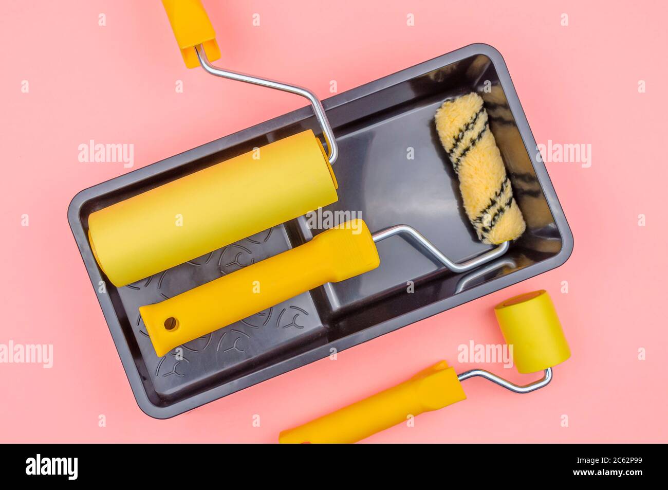 Construction tool for wallpaper on a pink background Stock Photo - Alamy