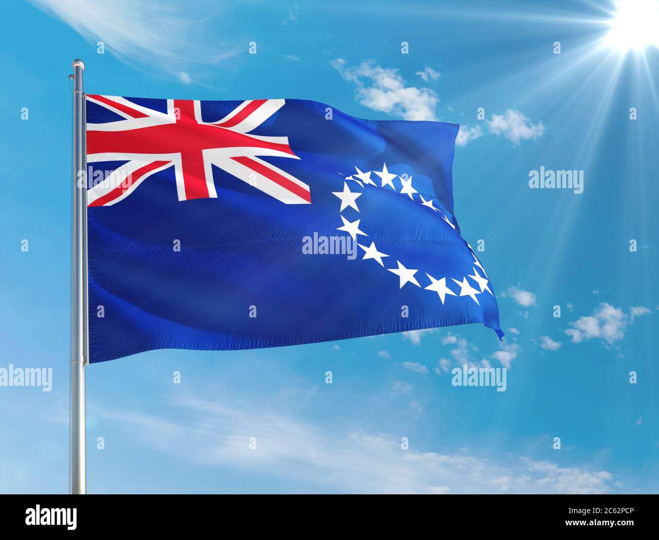 Cook Islands national flag waving in the wind against deep blue sky ...