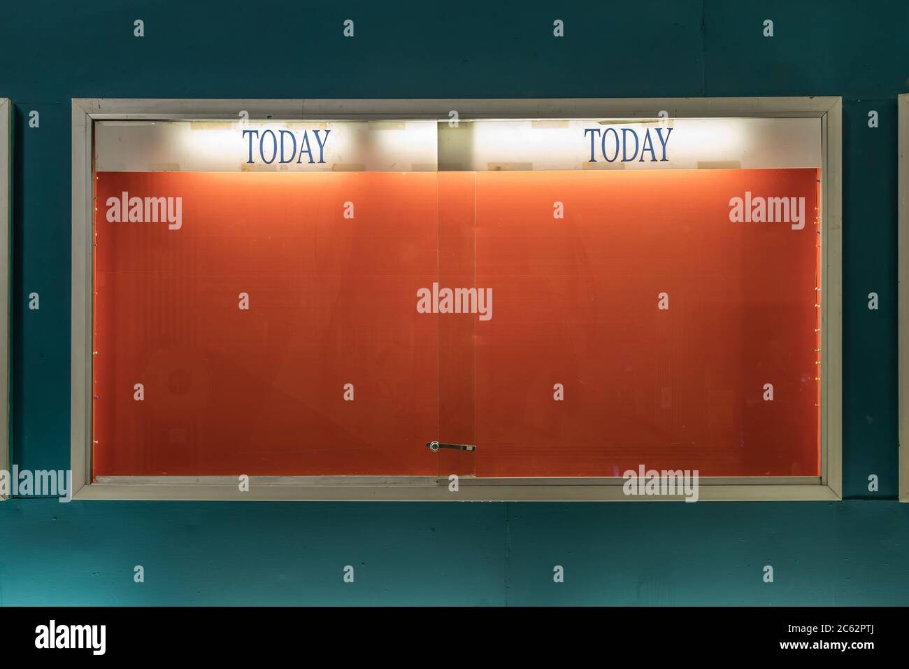 Empty frame of movie posters with spotlight on wall at old standalone ...