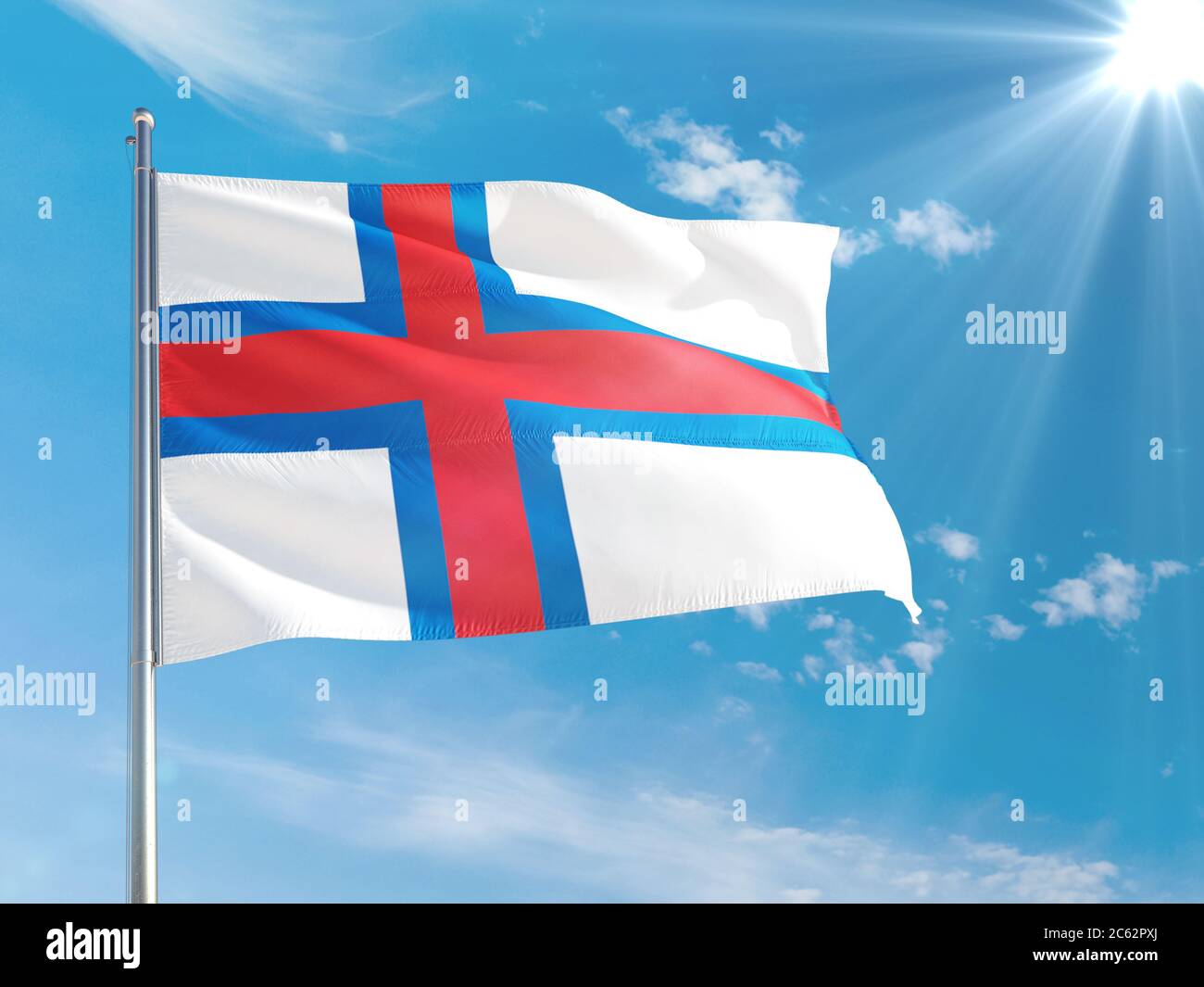 Faroe Islands national flag waving in the wind against deep blue sky ...