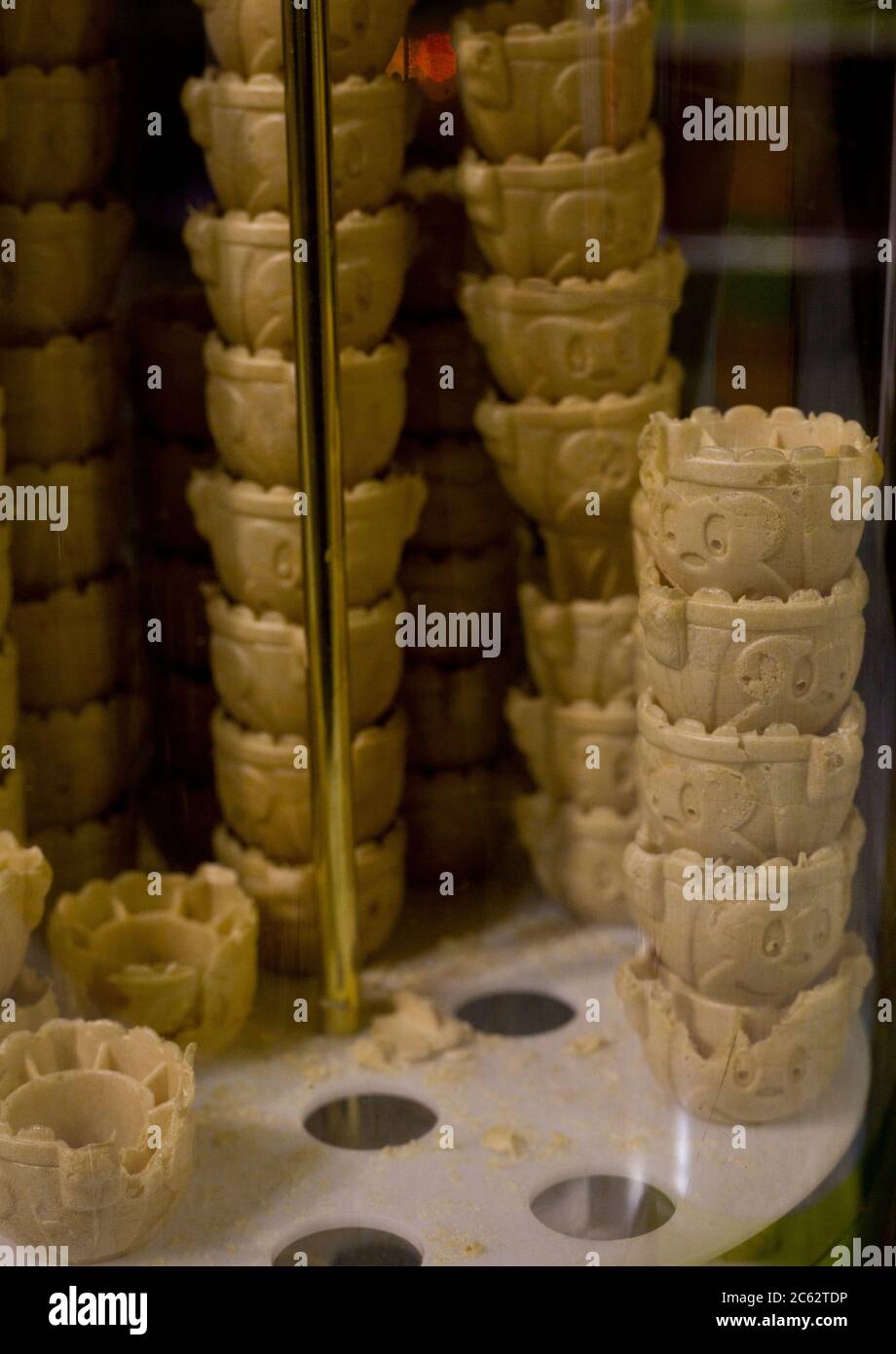 Ice cream cones stacked up in a dispenser, ice cream parlour, crunchy ...