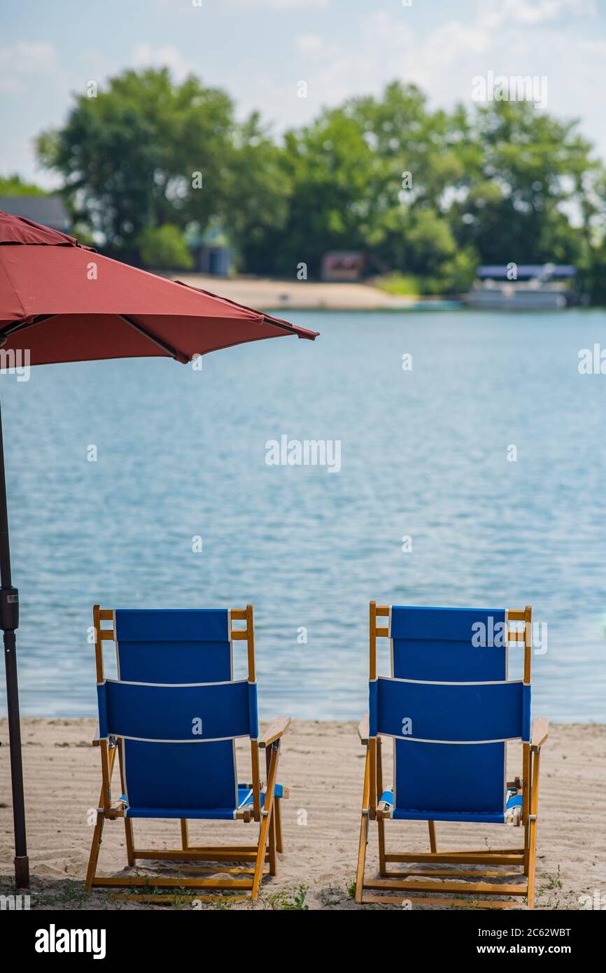 Two beach chairs overlooking lake Stock Photo - Alamy
