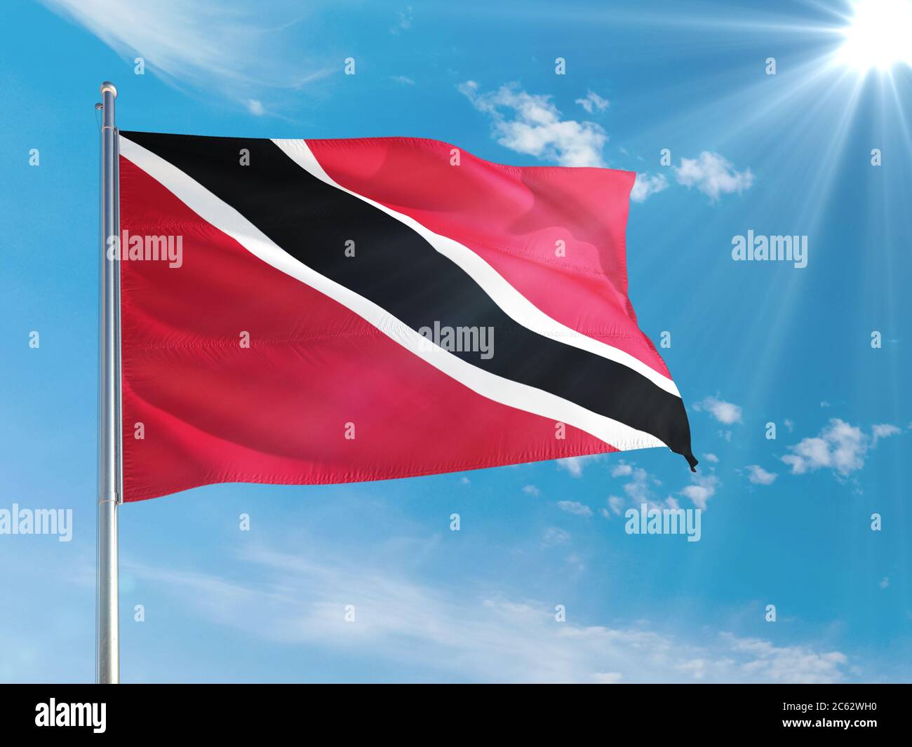 Trinidad And Tobago national flag waving in the wind against deep blue ...