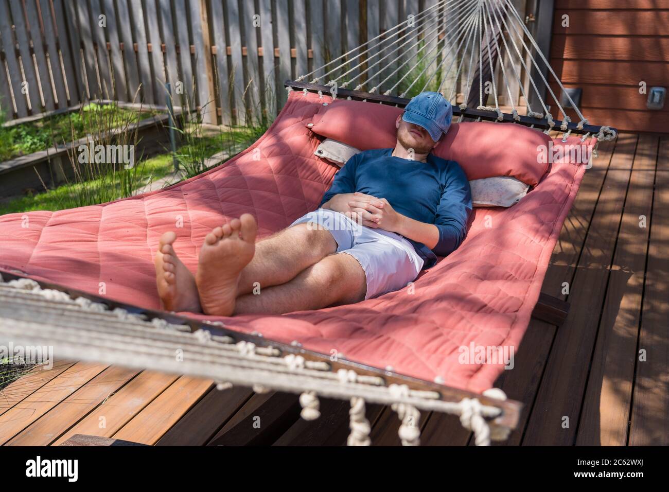 Young man napping in a hammock Stock Photo - Alamy
