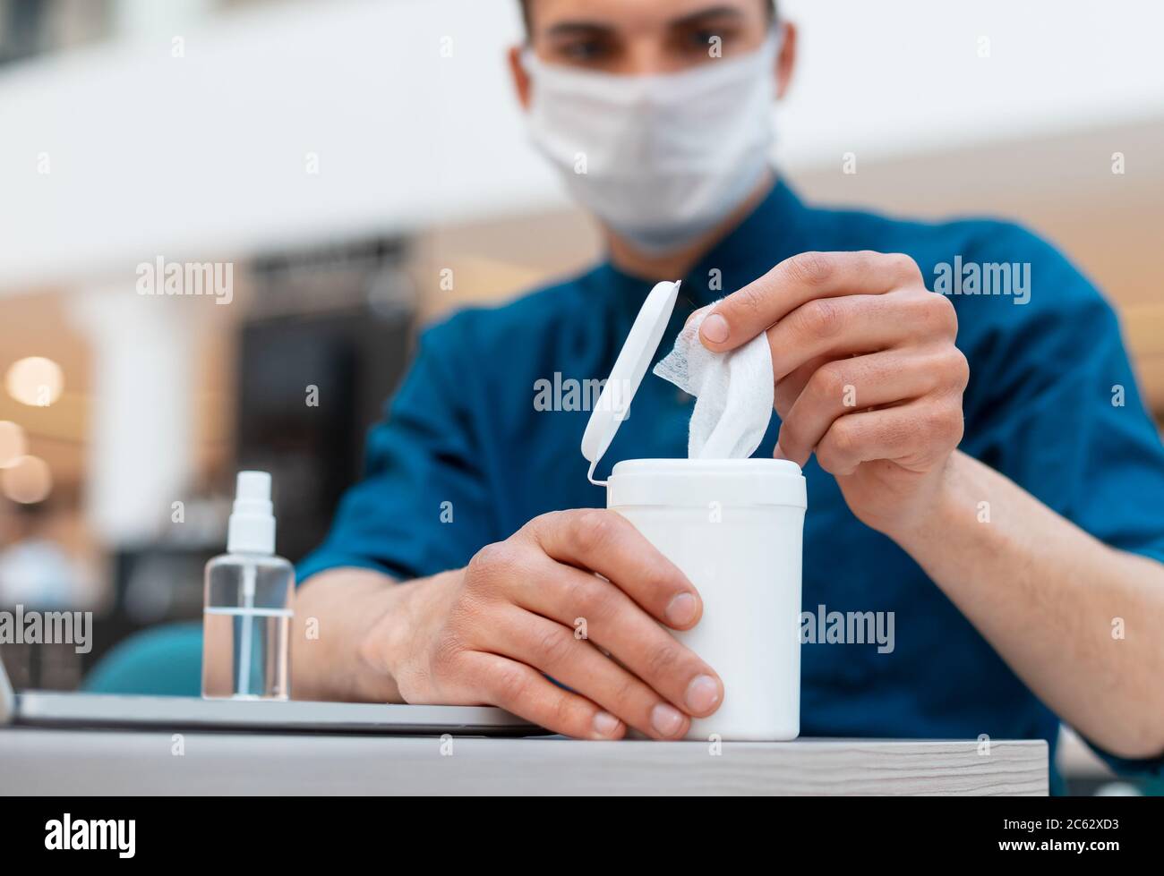 young man using antiseptic wipes in the workplace Stock Photo - Alamy