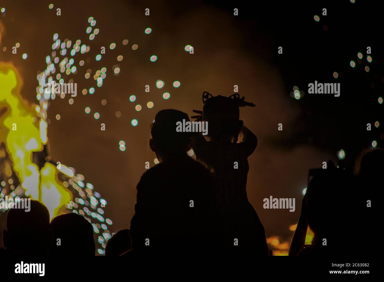 silhouettes of children on the background of fire fire. Children ...