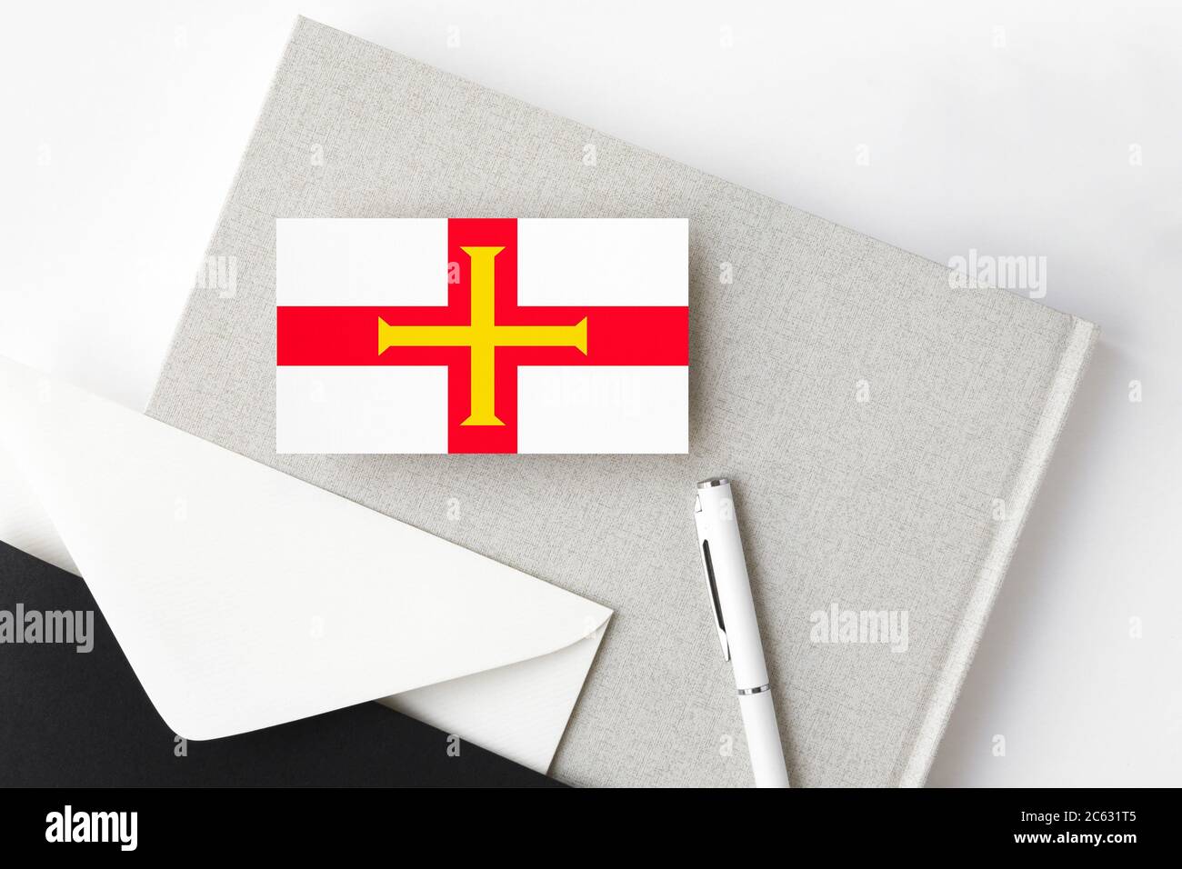 Guernsey flag on minimalist letter background. National invitation ...