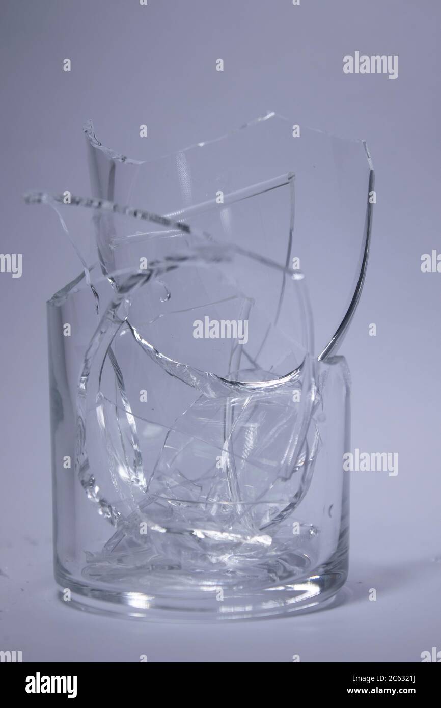 fragments of a broken glass in a broken glass on a white background ...