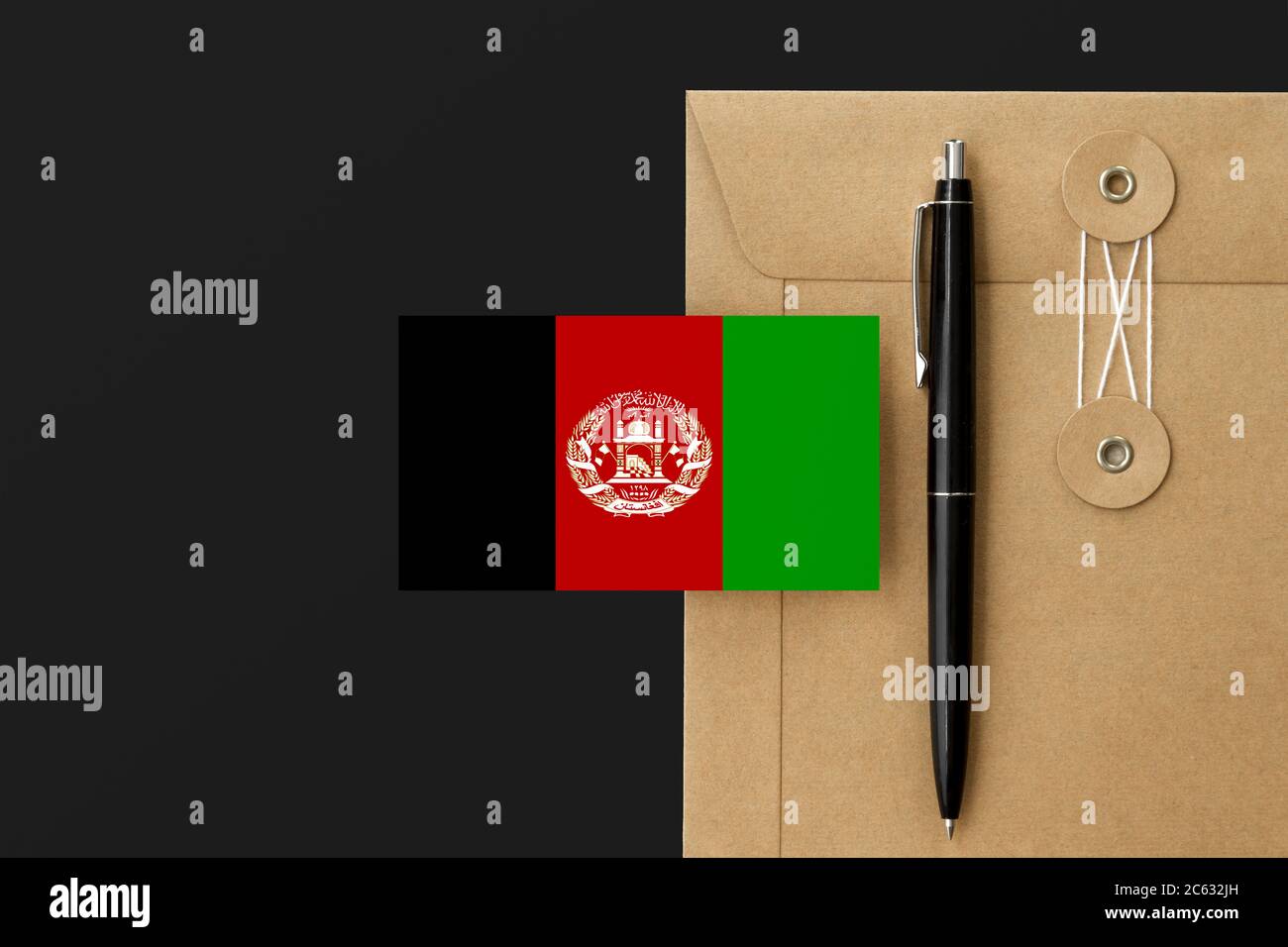 Afghanistan flag on craft envelope letter and black pen background ...