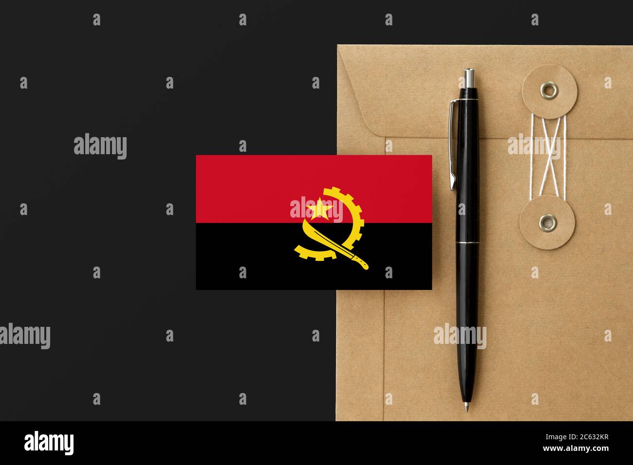 Angola flag on craft envelope letter and black pen background. National ...
