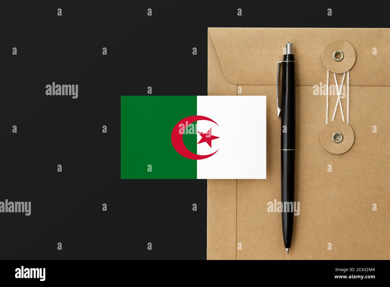 Algeria flag on craft envelope letter and black pen background ...