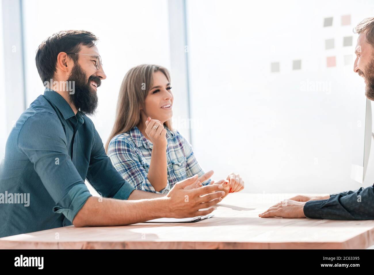 business colleagues discussing current tasks sitting at the Desk Stock ...