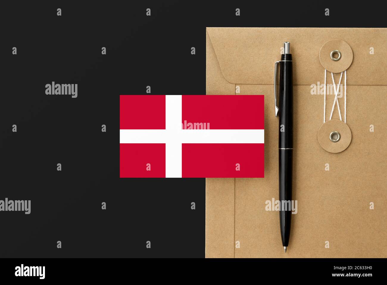 Denmark flag on craft envelope letter and black pen background ...