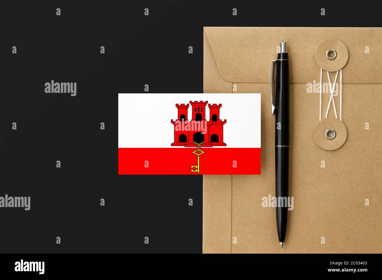 Gibraltar flag on craft envelope letter and black pen background ...