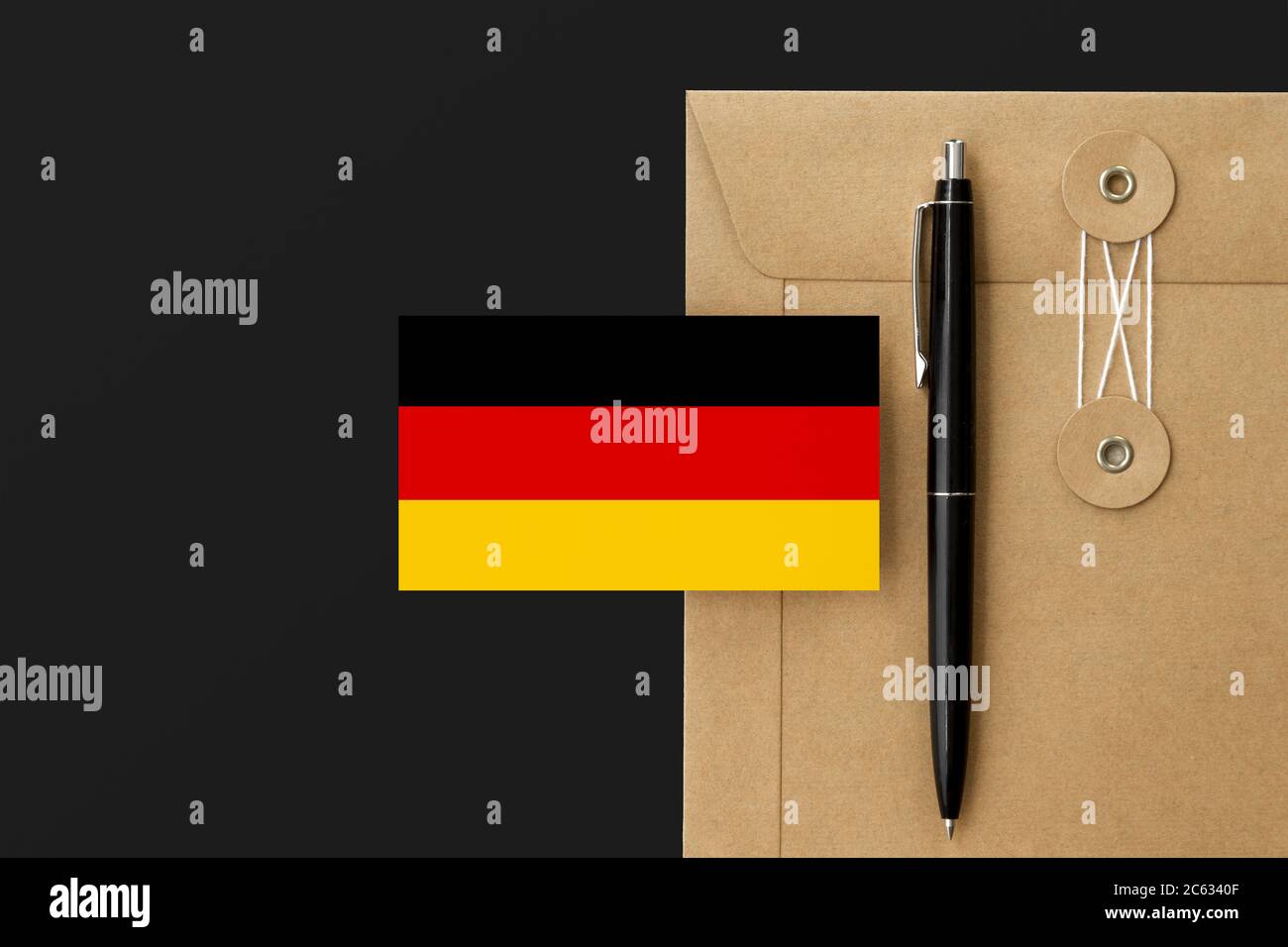 Germany flag on craft envelope letter and black pen background ...