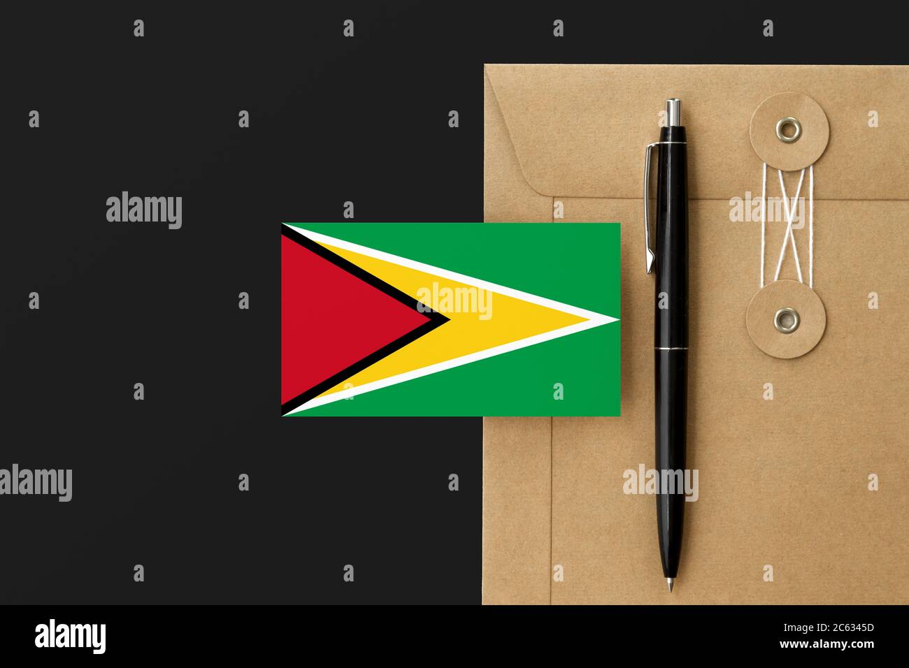 Guyana flag on craft envelope letter and black pen background. National ...