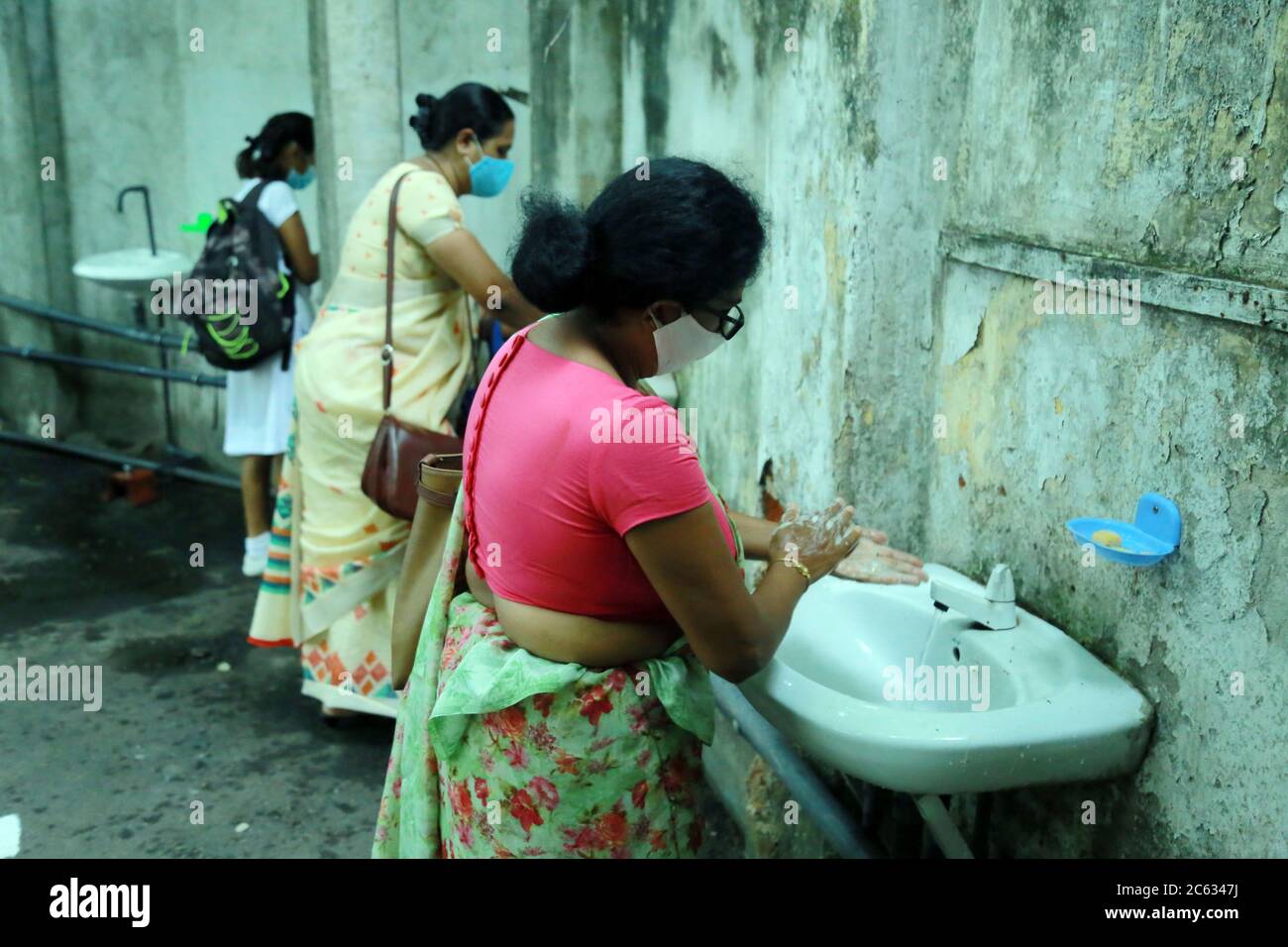 Colombo, Sri Lanka. 6th July, 2020. A teacher washes her hands at a ...