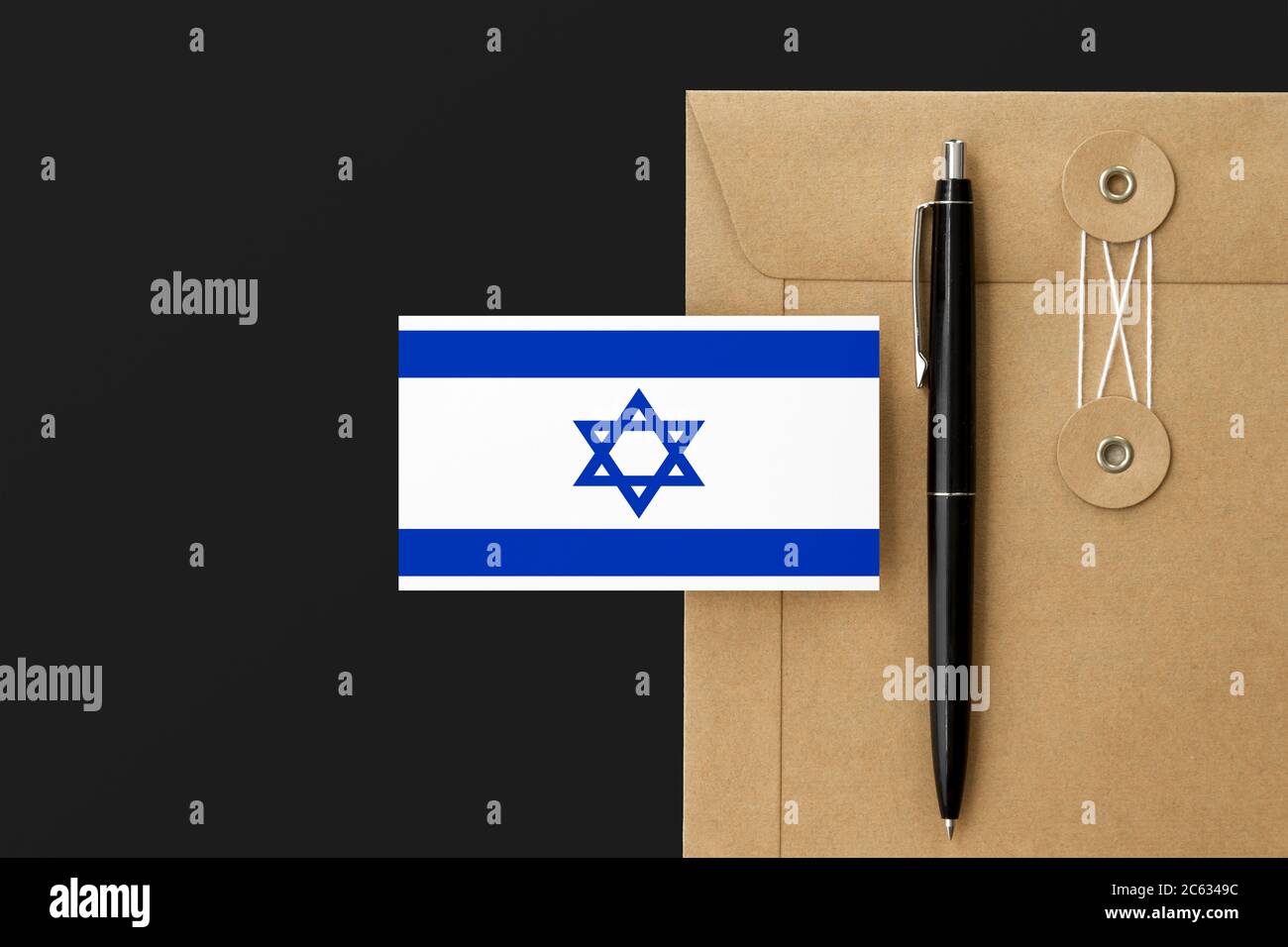 Israel flag on craft envelope letter and black pen background. National ...