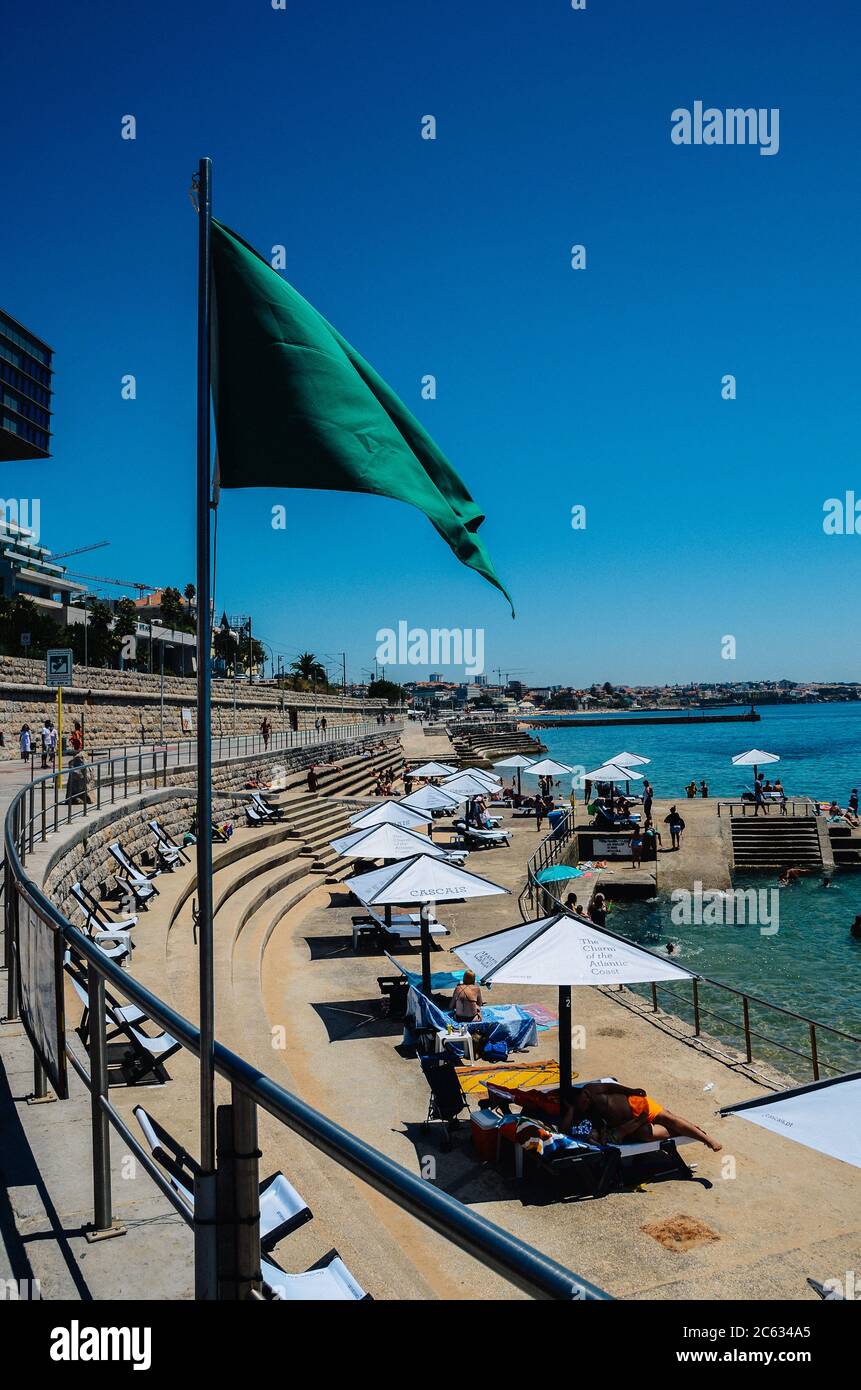 Green flag on a beach in Cascais, Portugal symbolizing that it's safe ...