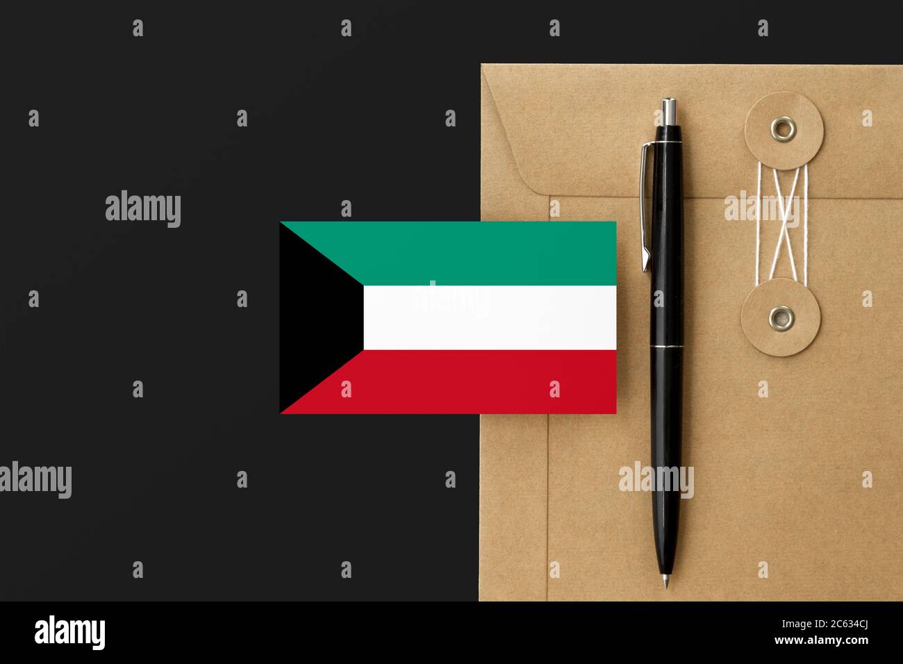 Kuwait flag on craft envelope letter and black pen background. National ...