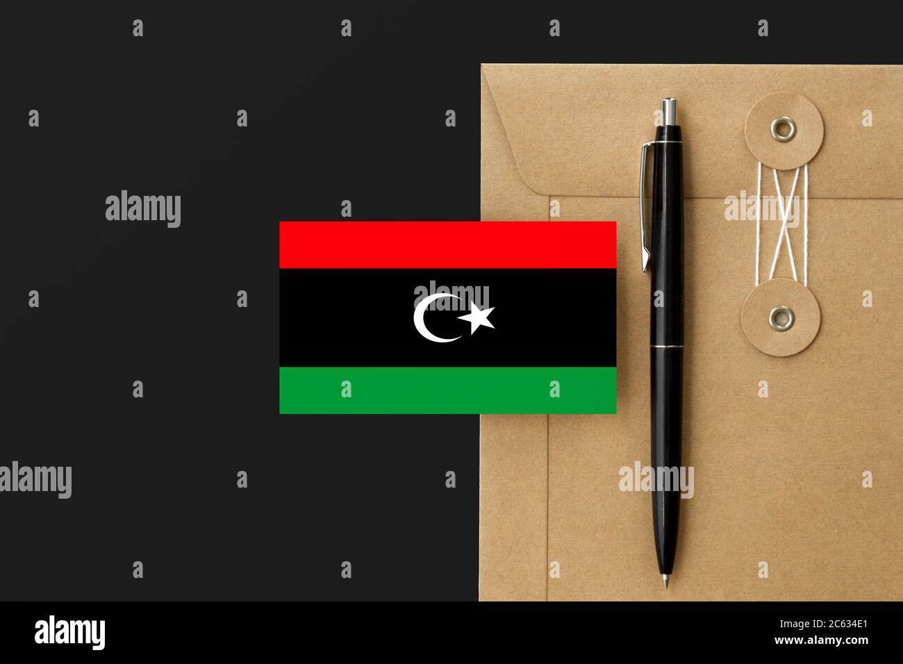 Libya flag on craft envelope letter and black pen background. National ...