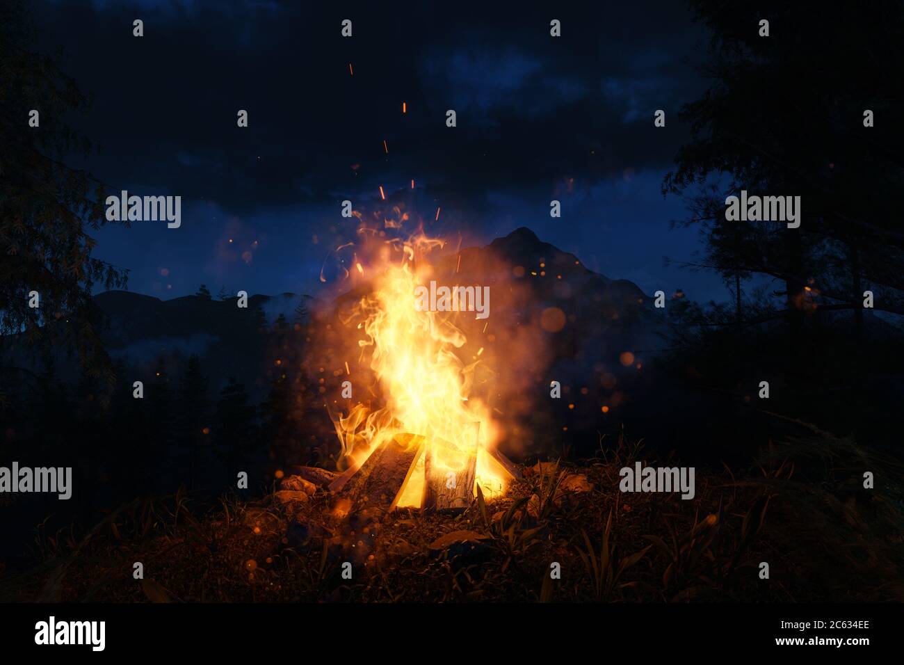 3d rendering of big bonfire with sparks and particles in front of foggy ...