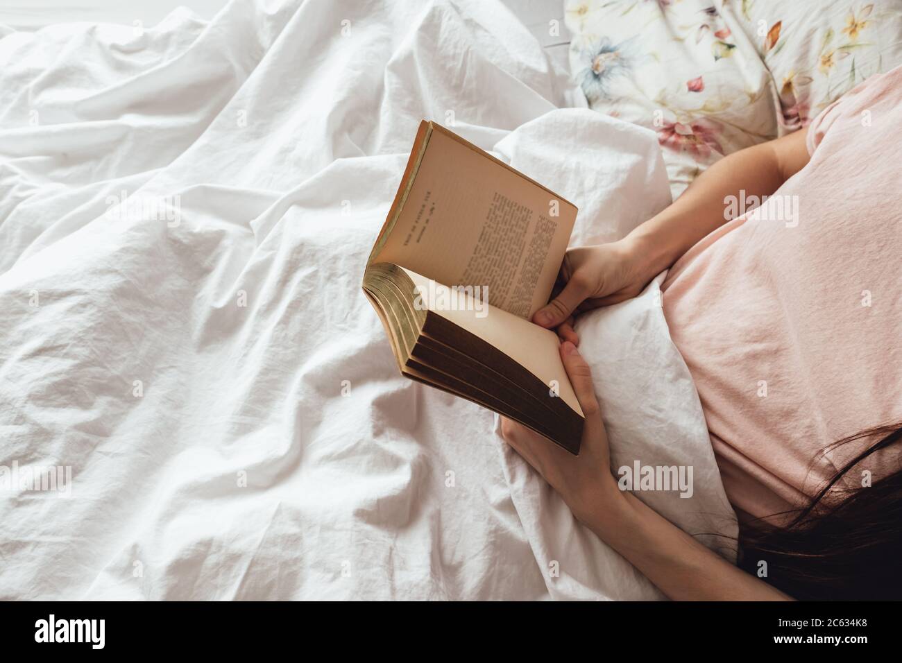 Woman holds open book in hands Stock Photo - Alamy