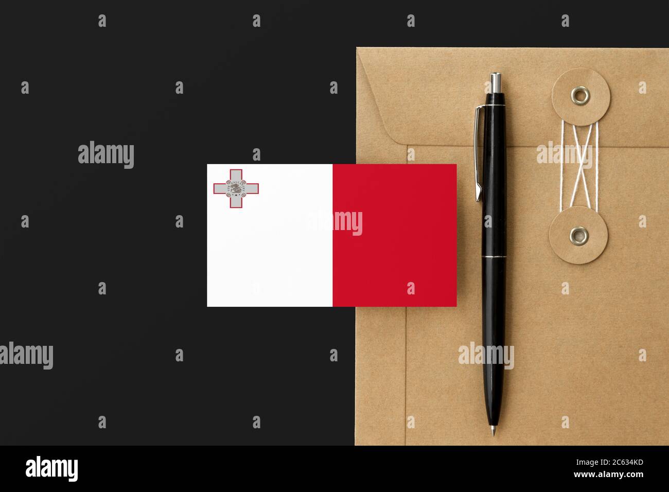 Malta flag on craft envelope letter and black pen background. National ...