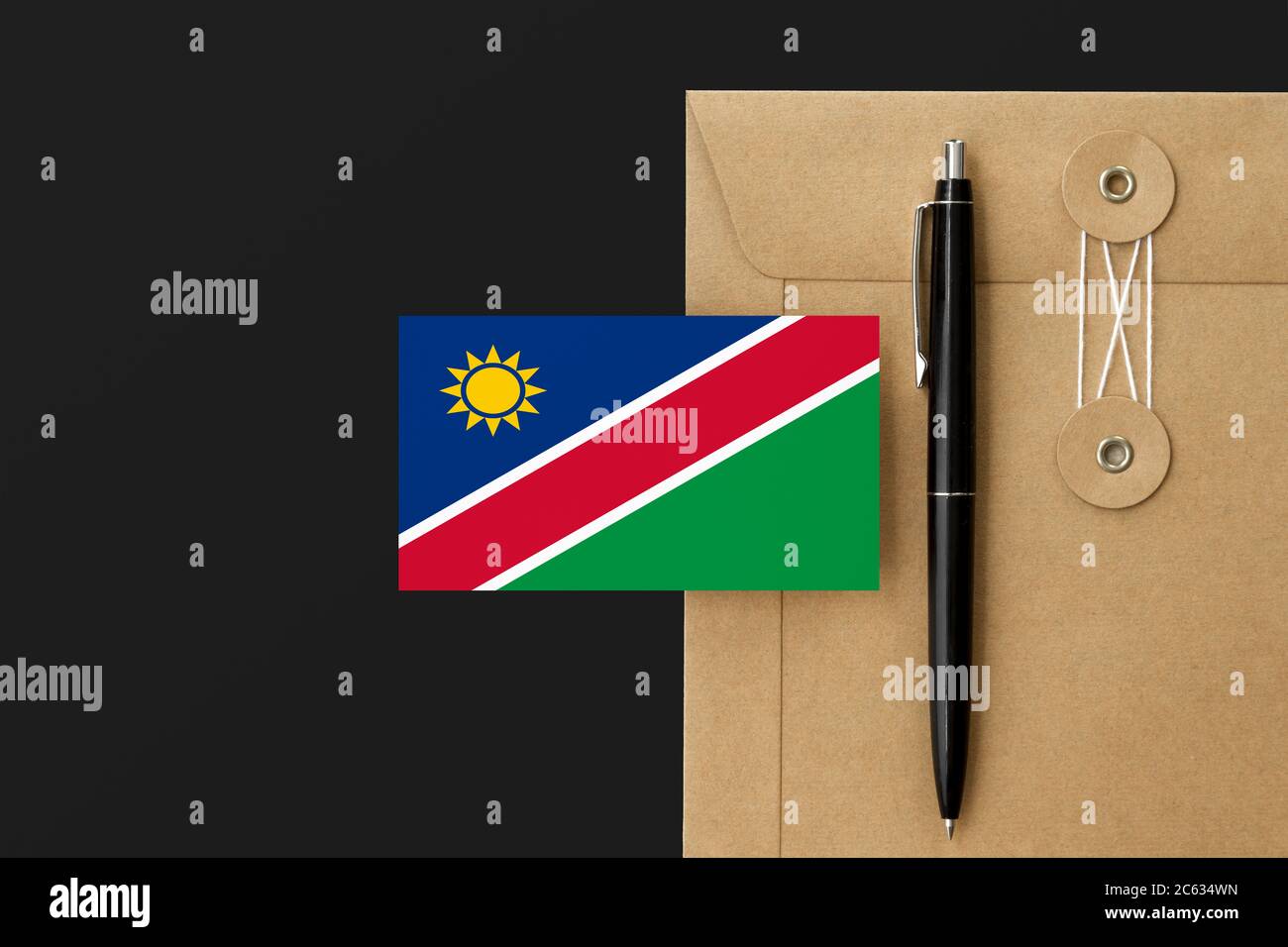 Namibia flag on craft envelope letter and black pen background ...