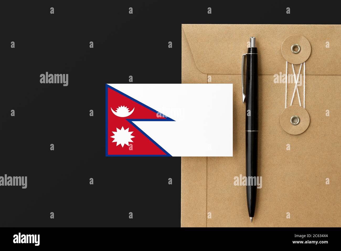 Nepal flag on craft envelope letter and black pen background. National ...