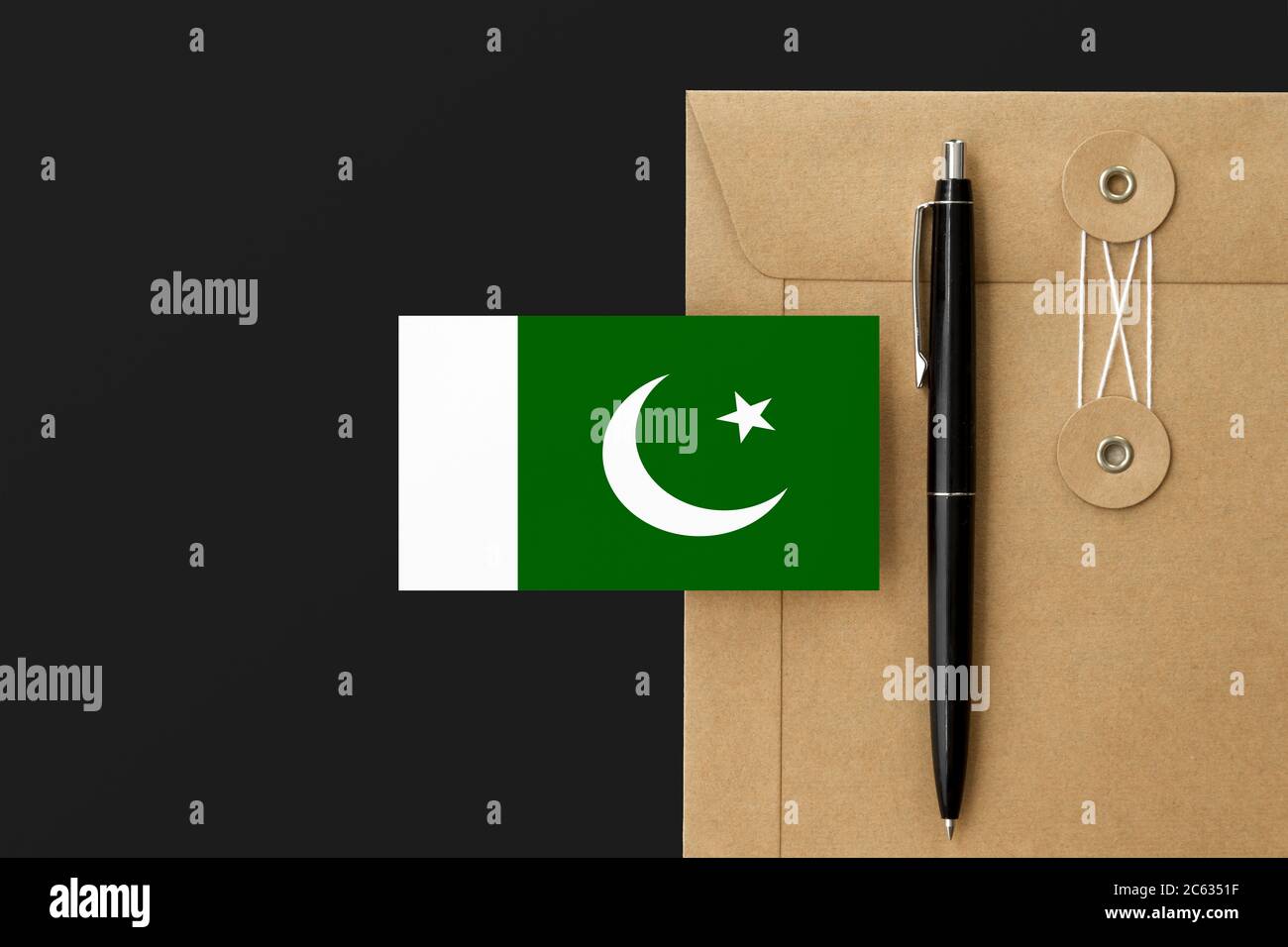 Pakistan flag on craft envelope letter and black pen background ...