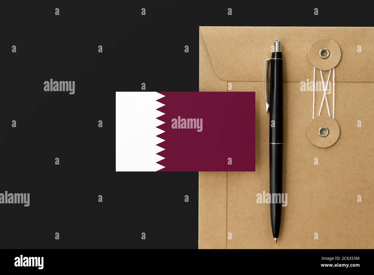 Qatar flag on craft envelope letter and black pen background. National ...