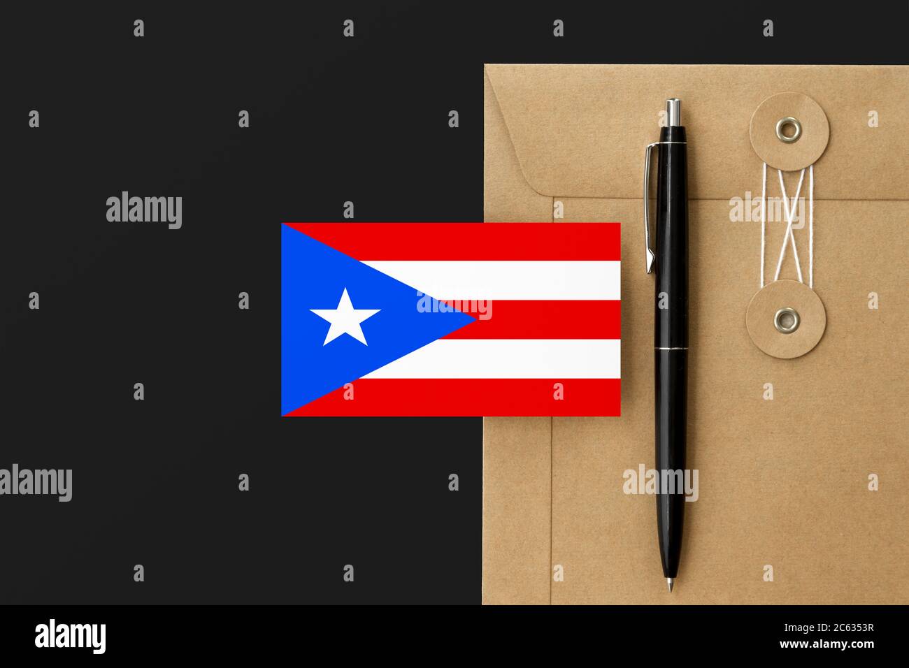 Puerto Rico flag on craft envelope letter and black pen background ...