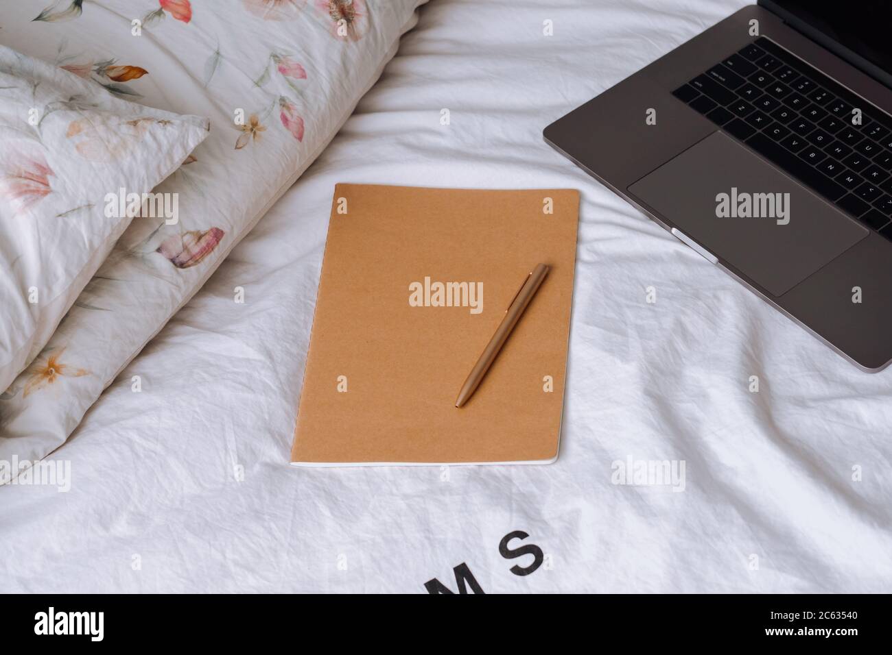 A laptop computer sitting on top of a bed Stock Photo - Alamy