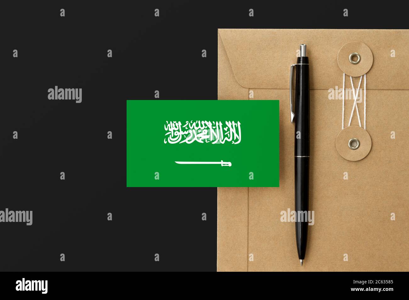 Saudi Arabia flag on craft envelope letter and black pen background ...