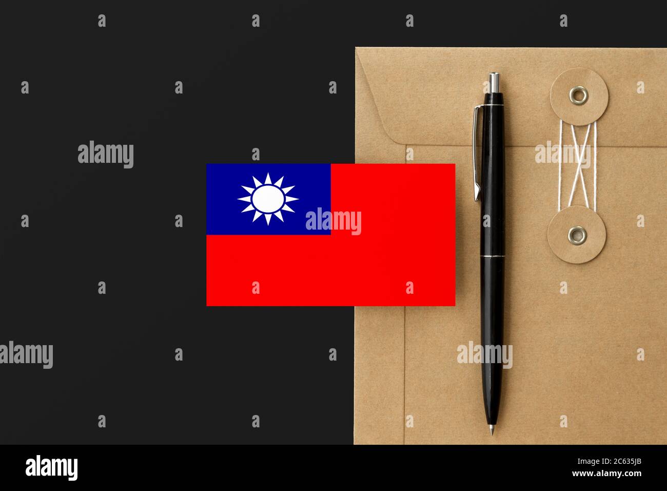 Taiwan flag on craft envelope letter and black pen background. National ...