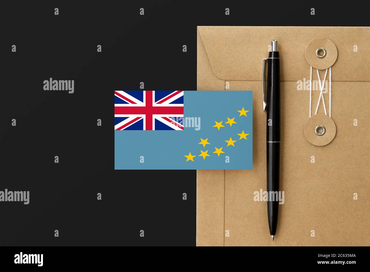 Tuvalu flag on craft envelope letter and black pen background. National ...