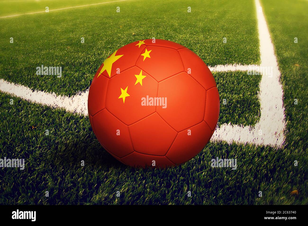China flag on ball at corner kick position, soccer field background ...