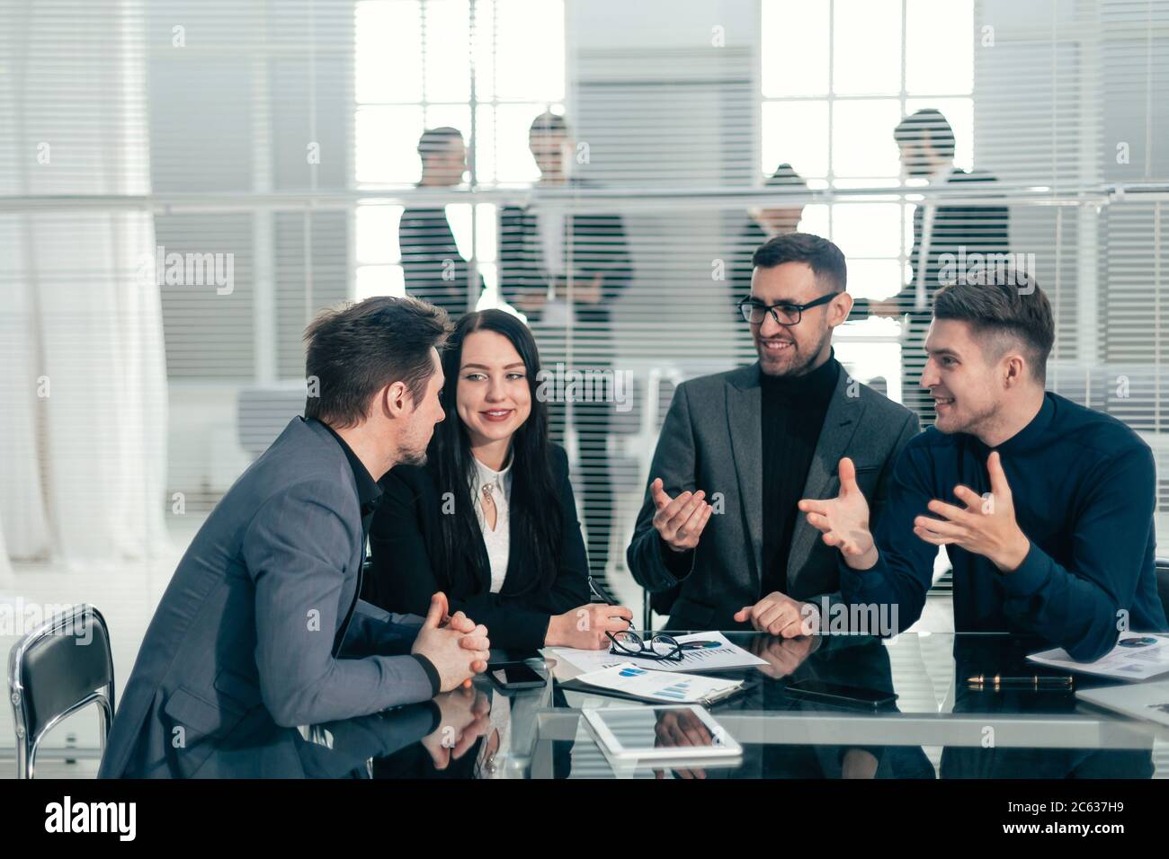 young employee explaining his ideas to colleagues Stock Photo - Alamy