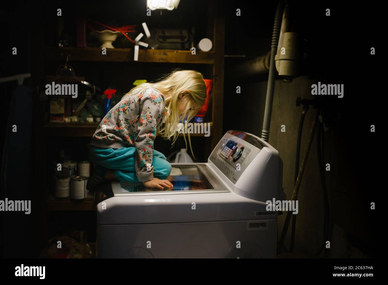 Girl sitting on washing machine hi-res stock photography and images - Alamy
