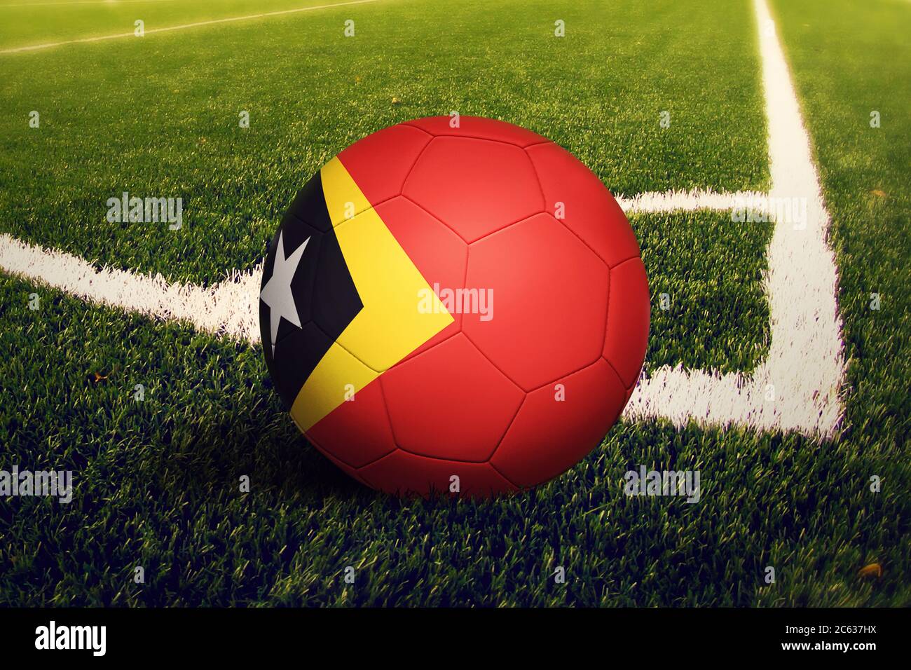 East Timor flag on ball at corner kick position, soccer field ...