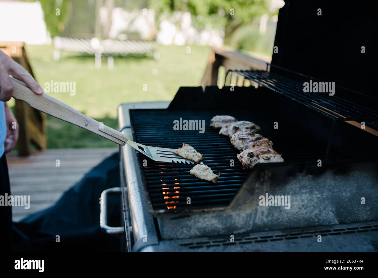 grilling chicken on the grill outside Stock Photo - Alamy