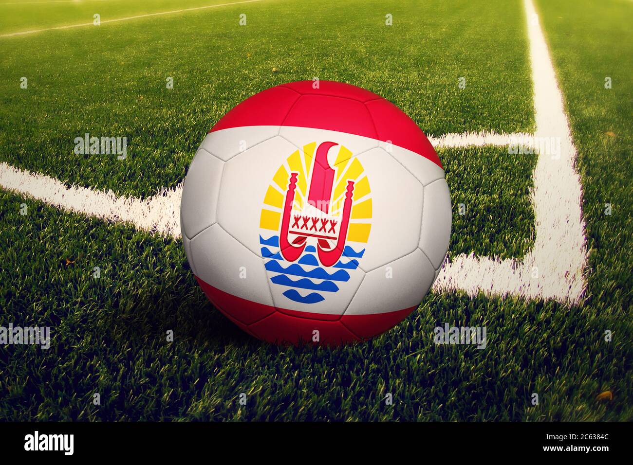 French Polynesia flag on ball at corner kick position, soccer field ...