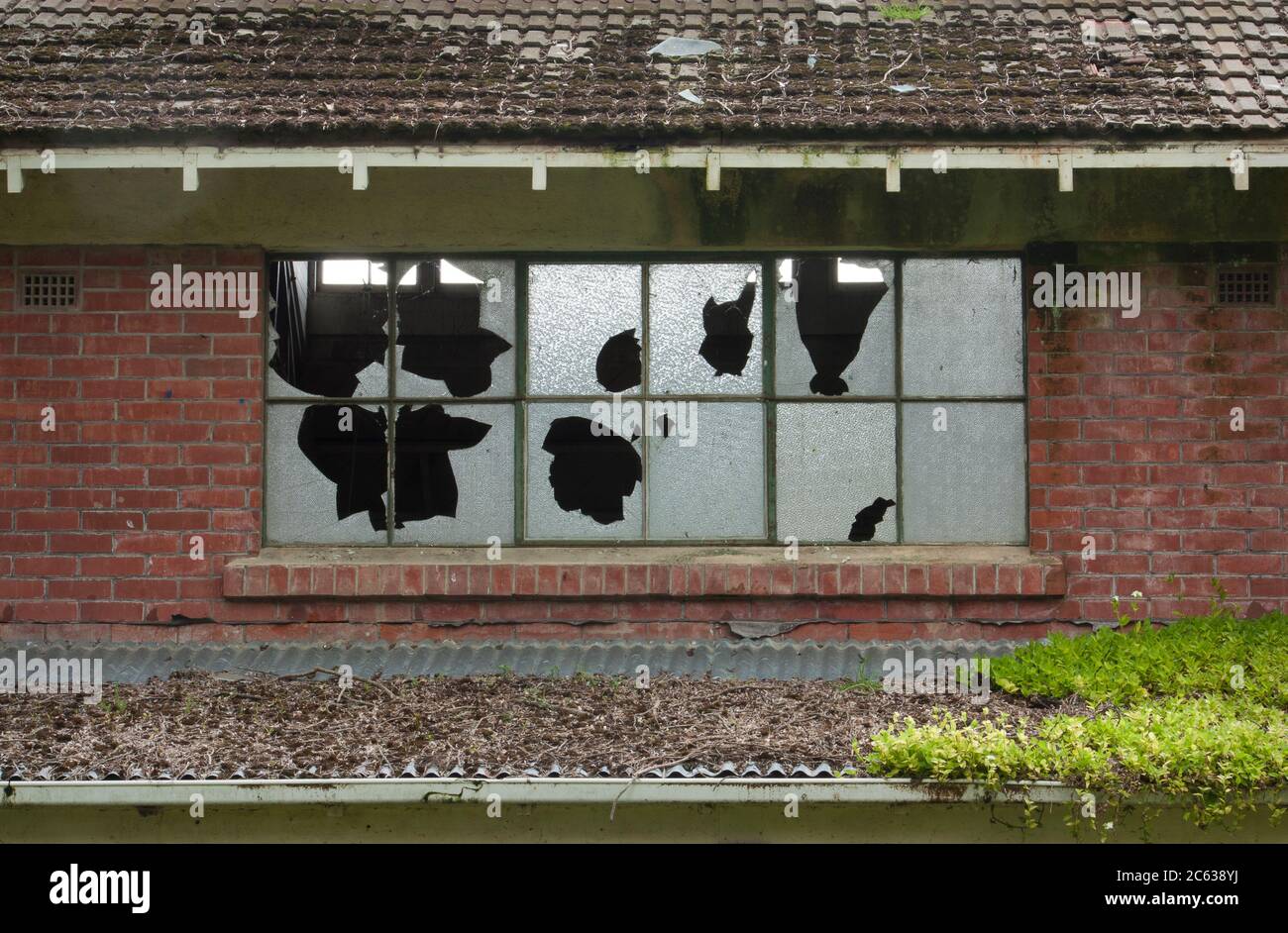 Broken windows in an old abandoned brick building Stock Photo - Alamy